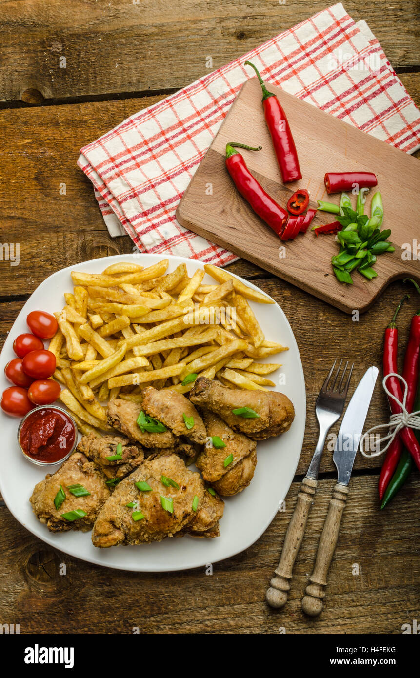 Fried chicken, chilli fries and dip and spring onions on top of meal ...