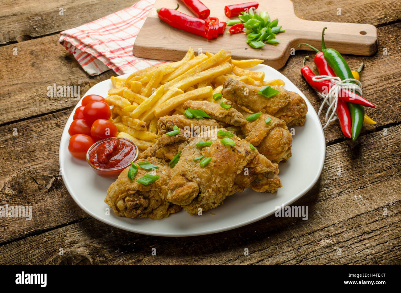 Fried chicken, chilli fries and dip and spring onions on top of meal ...
