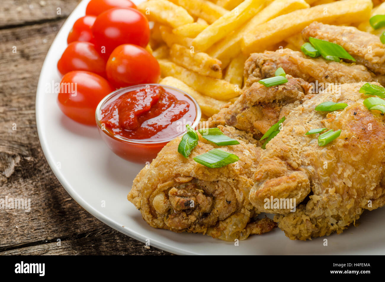 Fried chicken, chilli fries and dip and spring onions on top of meal ...