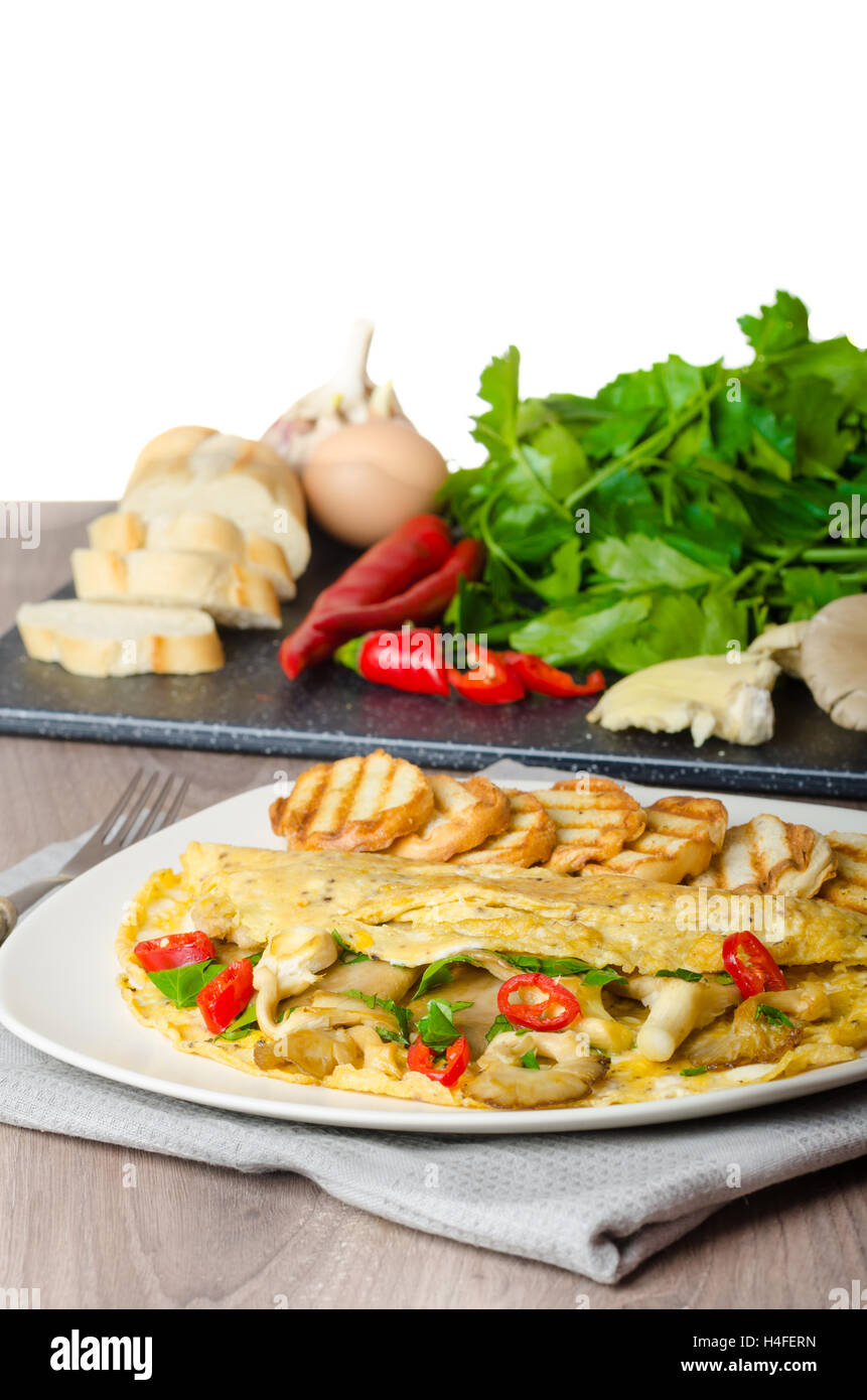 Rustic vegetarian omelette with chili peppers and mushrooms Stock Photo ...