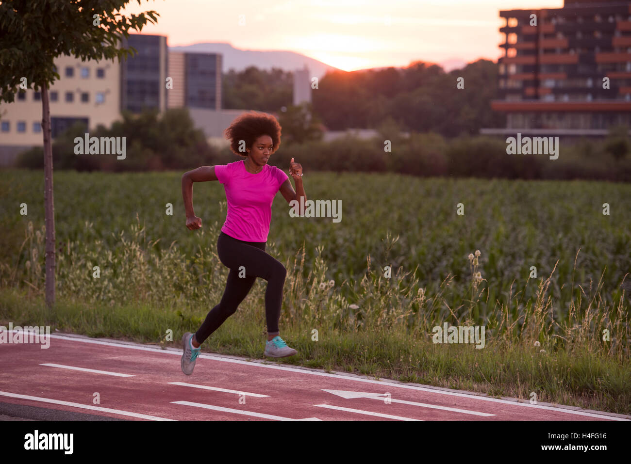 young beautiful African American woman enjoys running outside beautiful ...