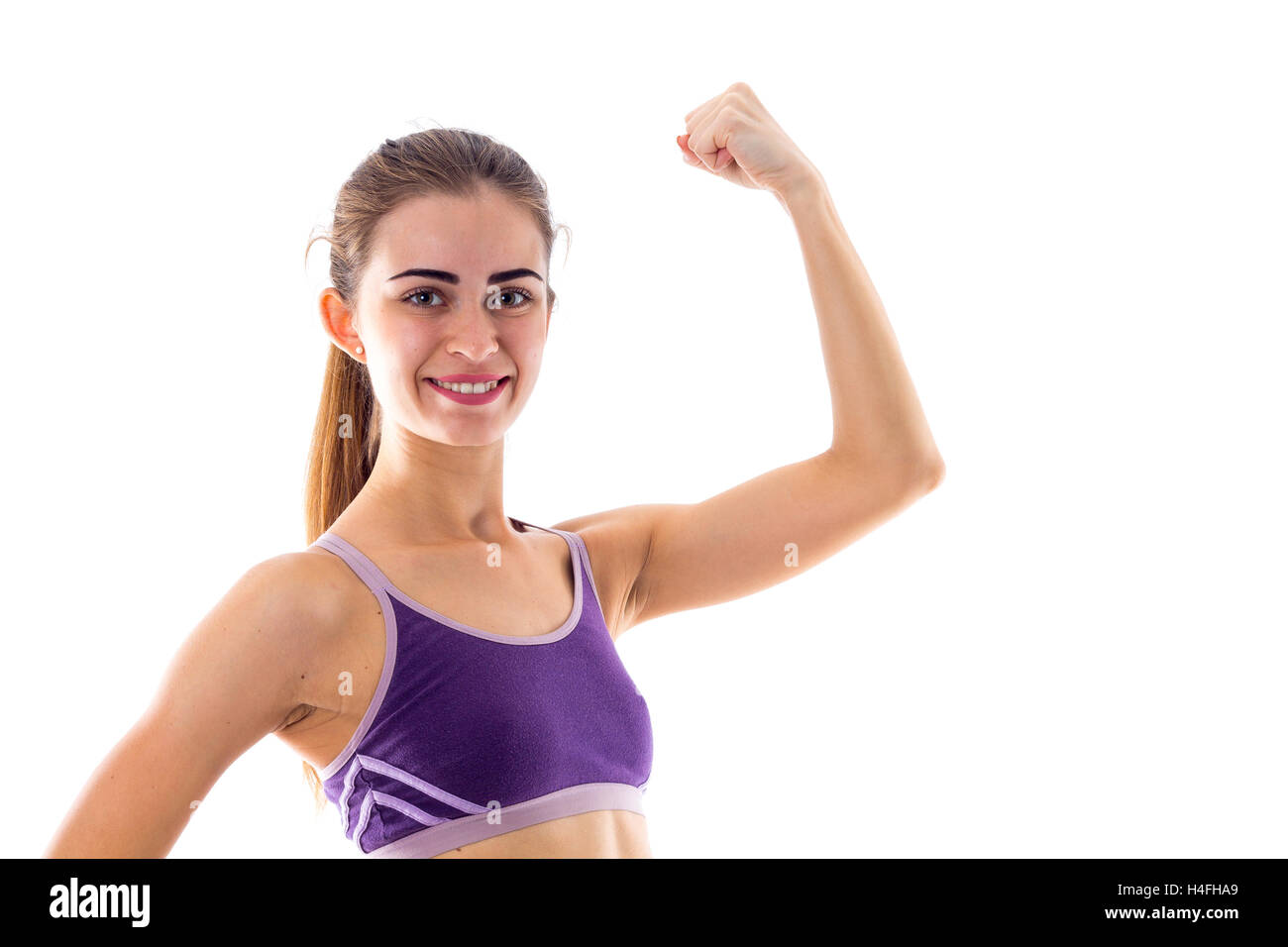 Athletic woman showing her biceps Stock Photo - Alamy