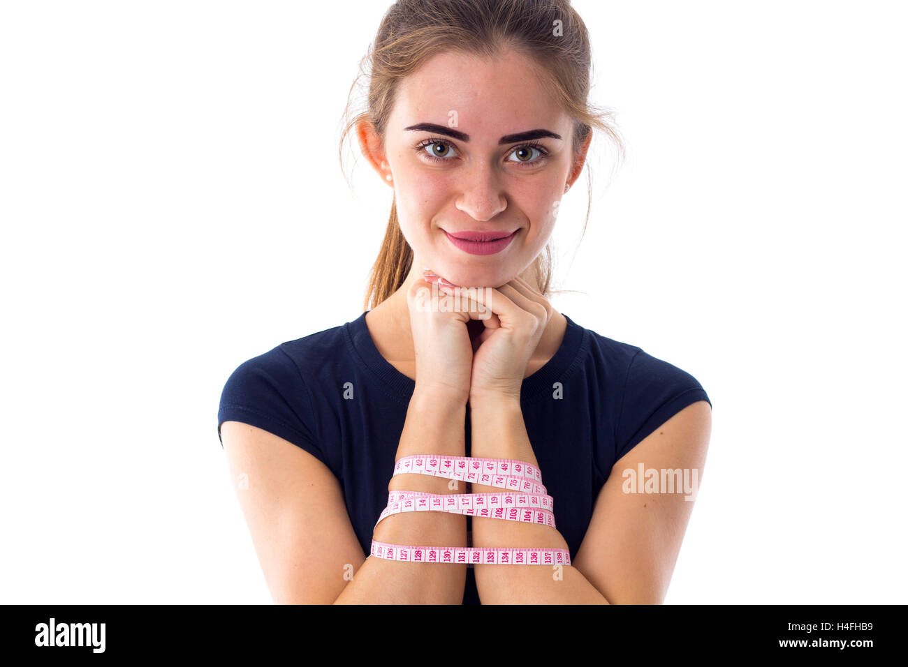 Woman holding centimeter around her arms Stock Photo - Alamy