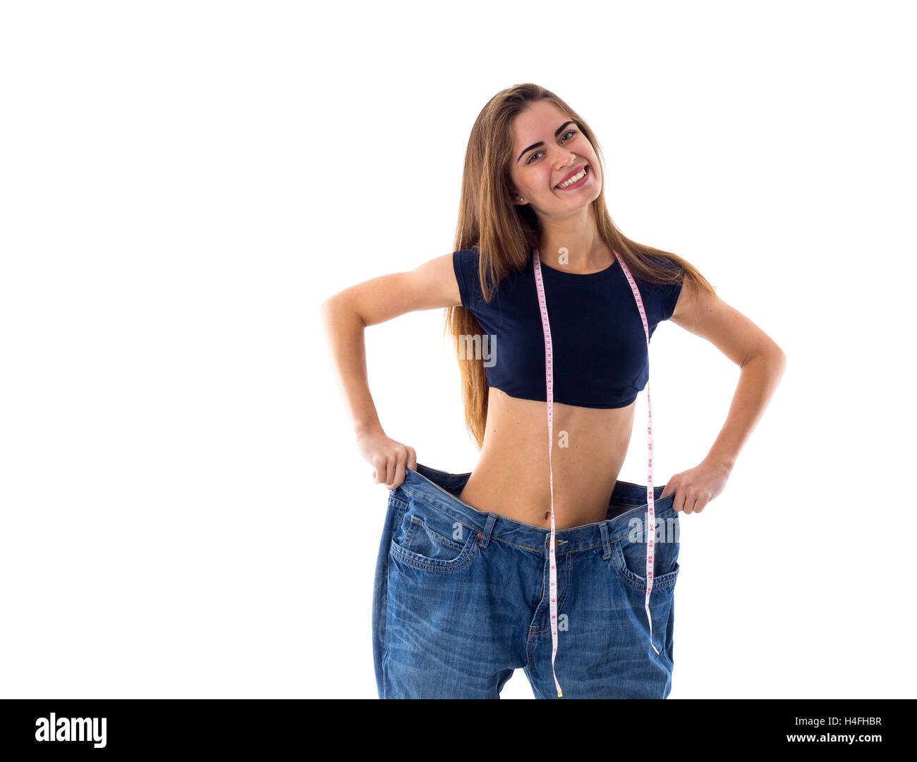 Woman wearing jeans of much bigger size Stock Photo - Alamy