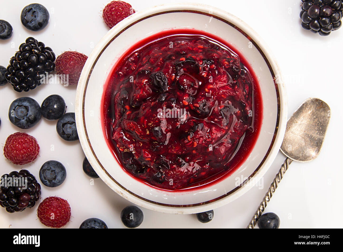 Berry jam in jam dish on white background Stock Photo - Alamy