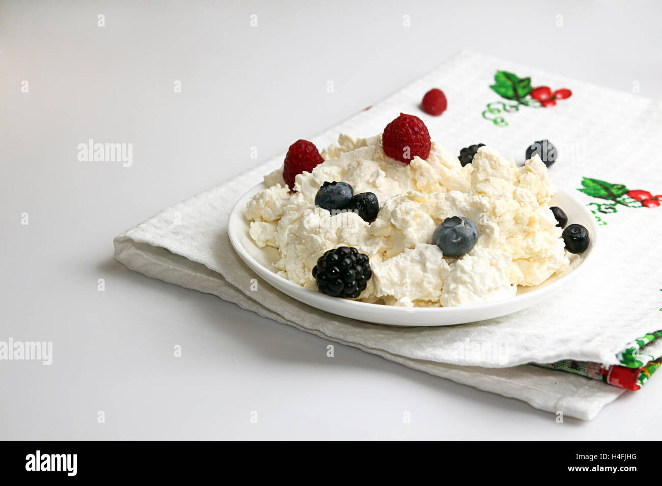 Cottage cheese in white plate on white background Stock Photo - Alamy