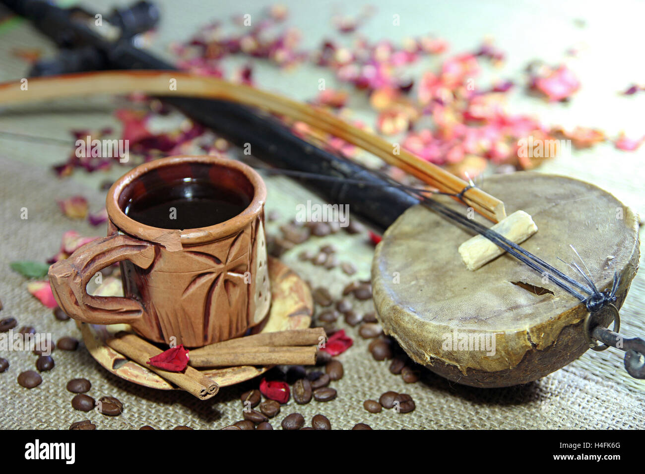 Still life with ceramic cup of coffee, Egyptian musical instrument and ...