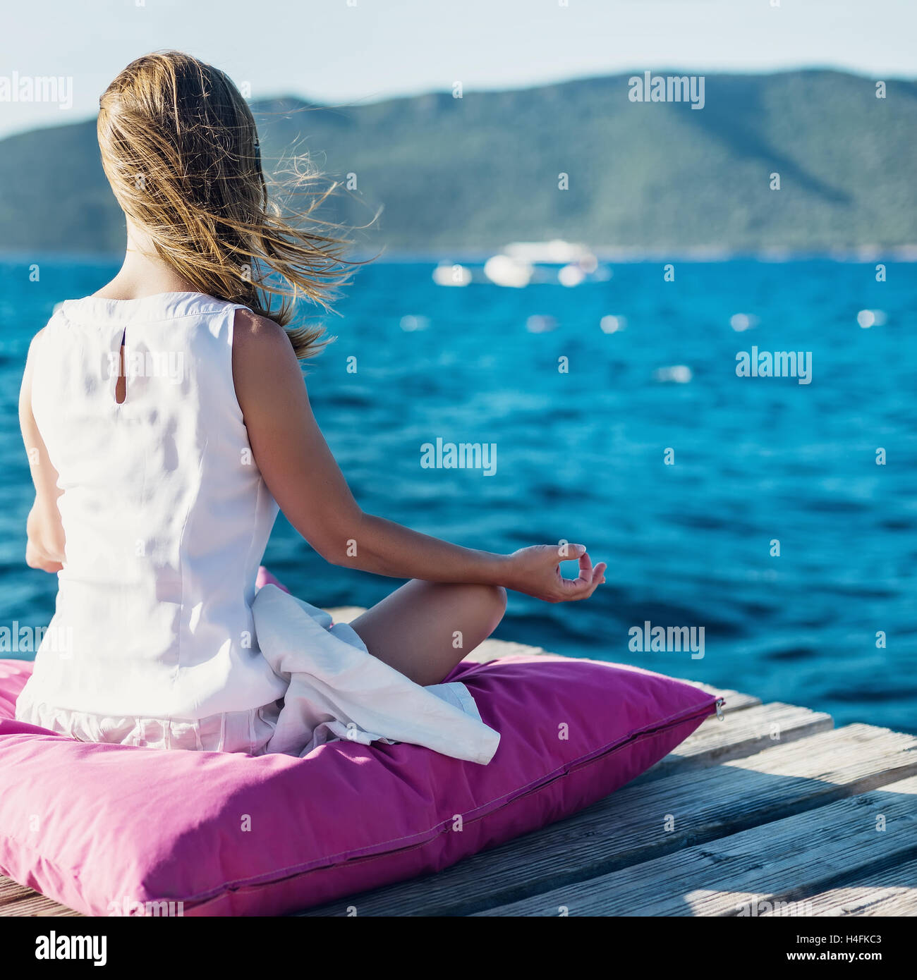Woman meditating at the sea Stock Photo - Alamy