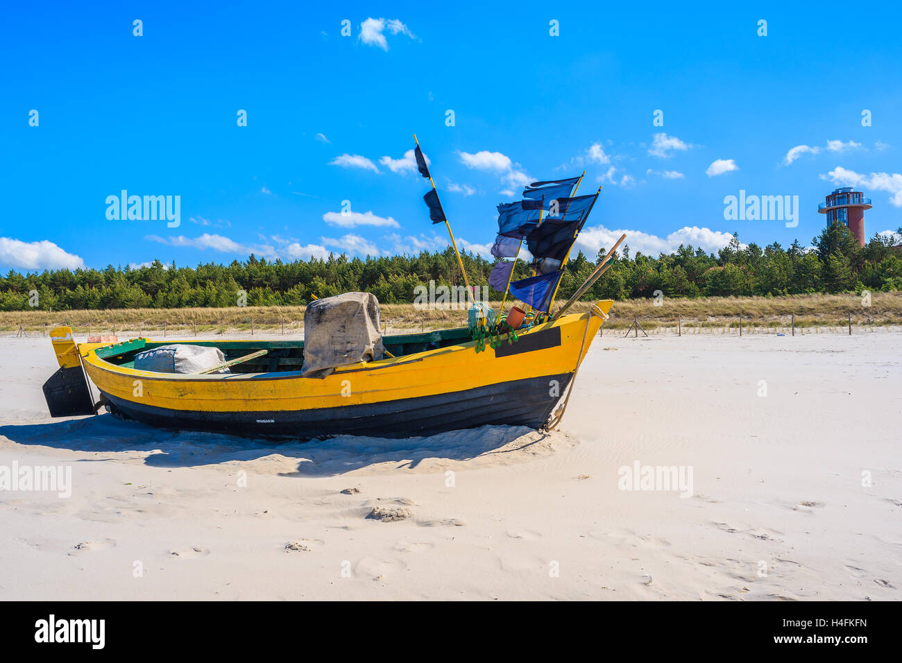 Colorful traditional fishing boat on sandy Baltic Sea beach in Debki ...