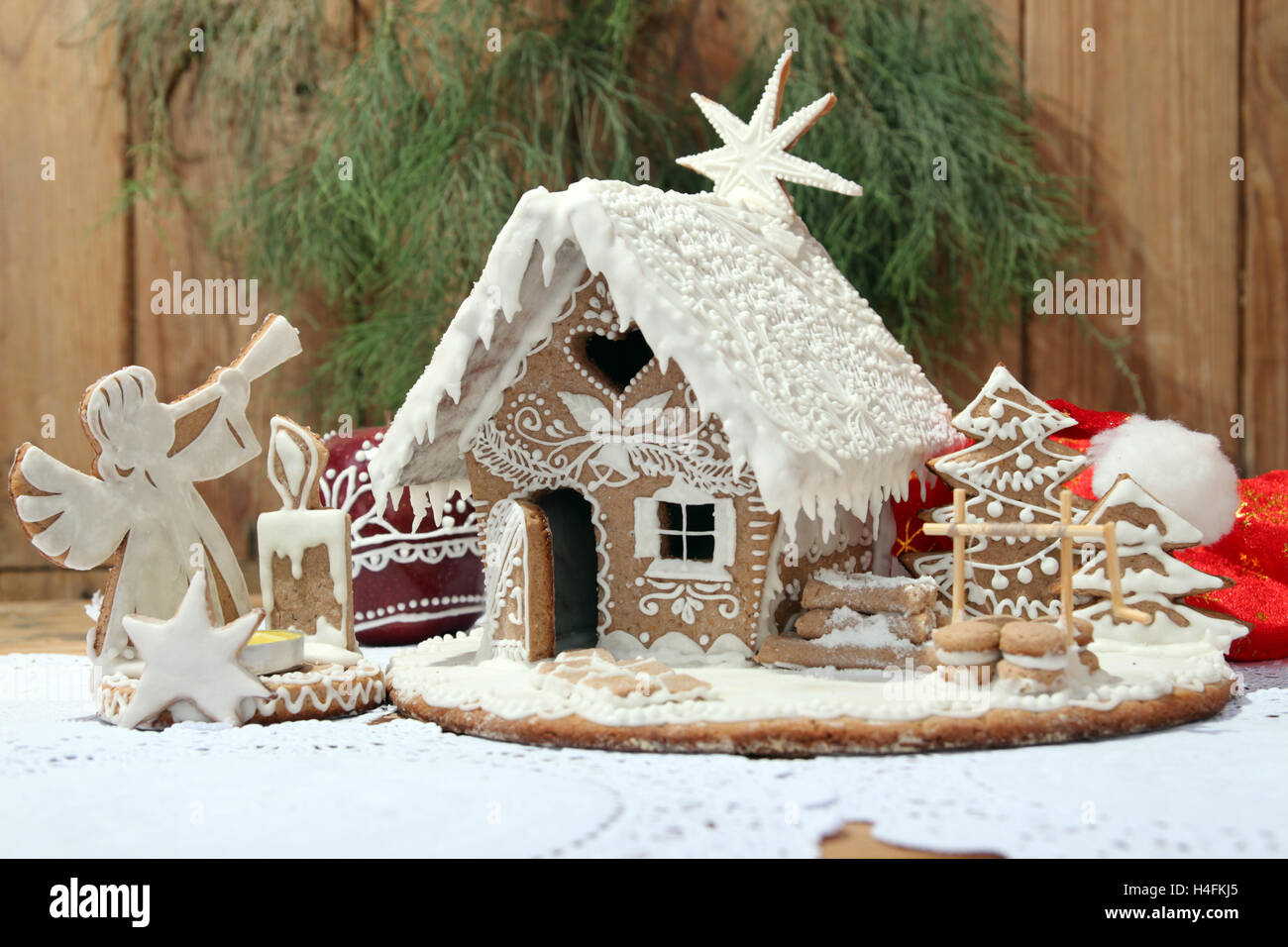 Gingerbreadhouse with candle in shape angel Stock Photo - Alamy