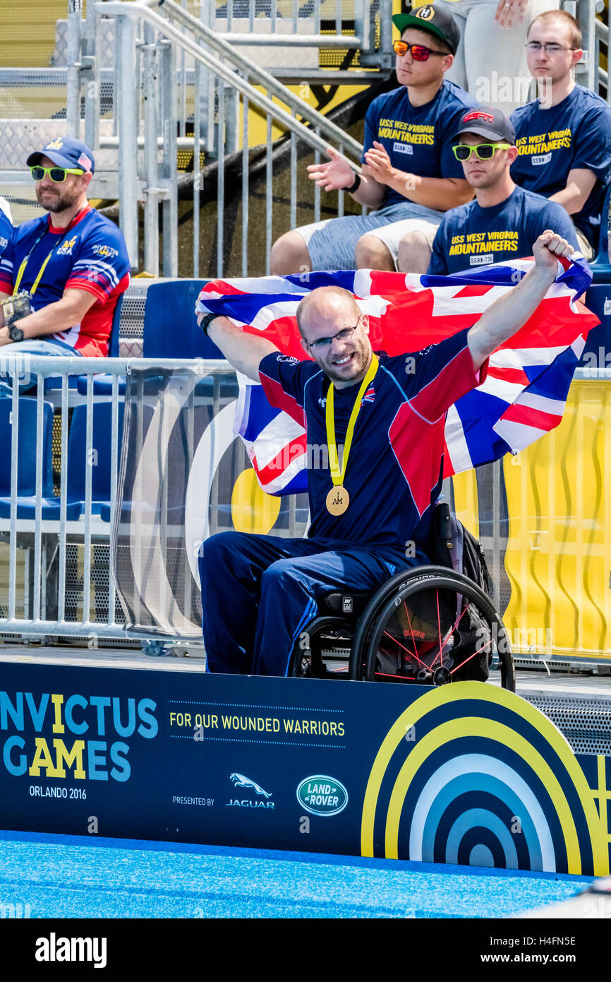 Adam Nixon, of the United Kingdom, proudly displays the gold medal he ...