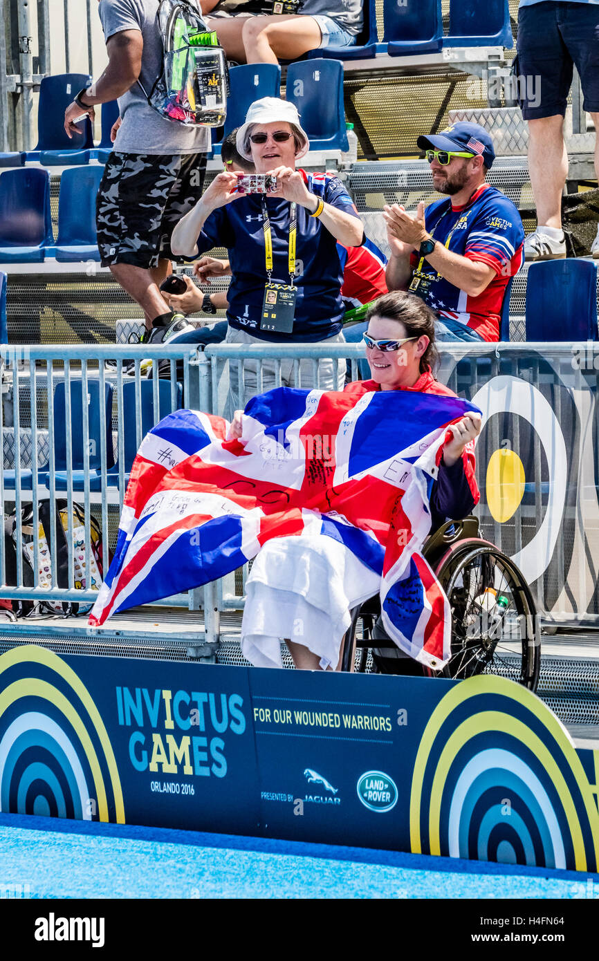 Jennifer Warren, from the United Kingdom, proudly waits to receive a ...