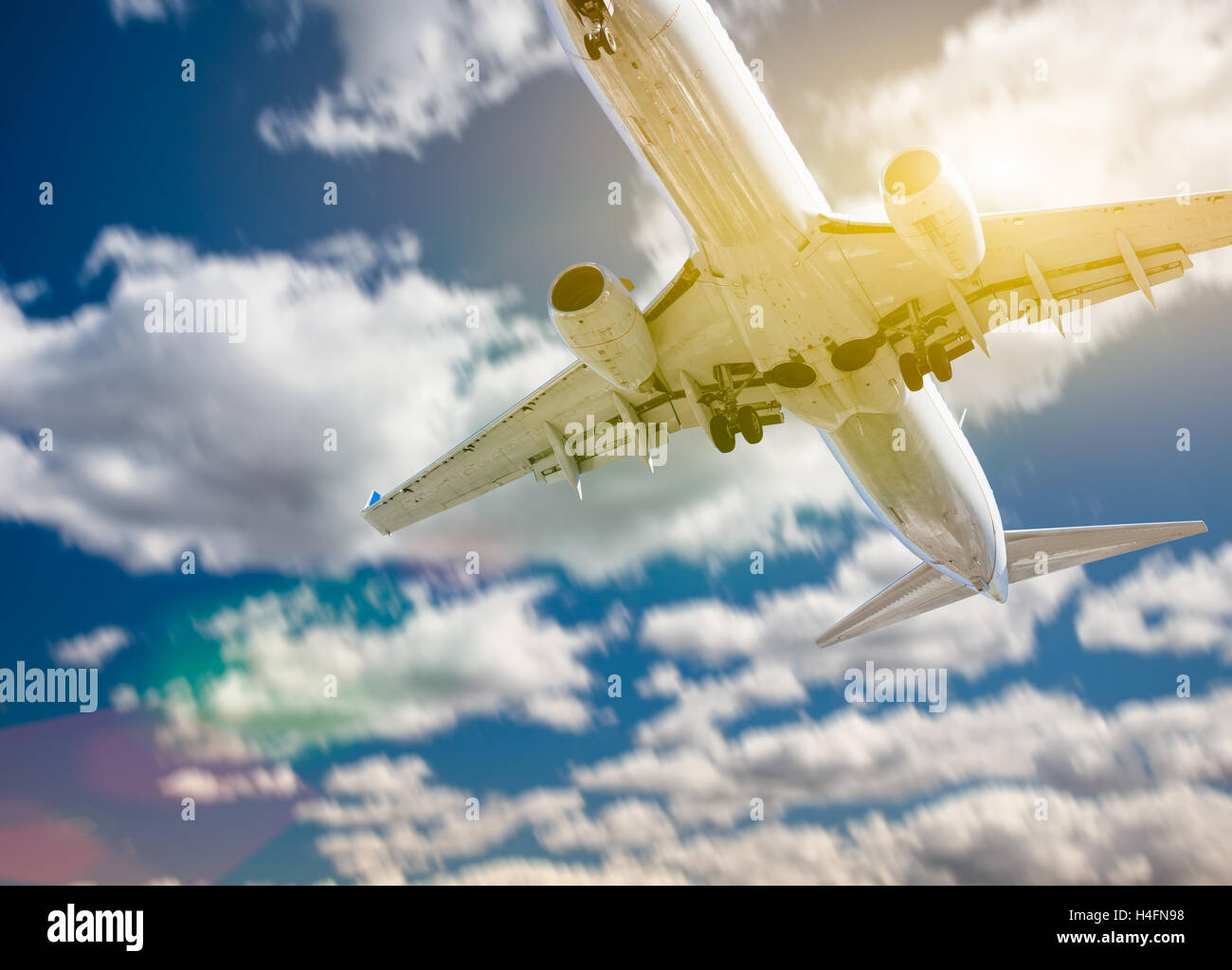Jet Airplane Landing with Dramatic Clouds and Sky Behind Stock Photo ...