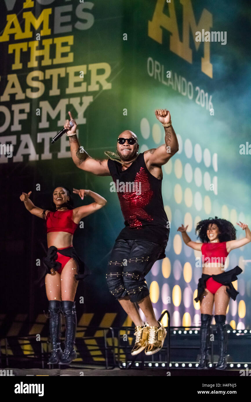 Flo Rida along with two of his backup dancers perform at the Closing ...