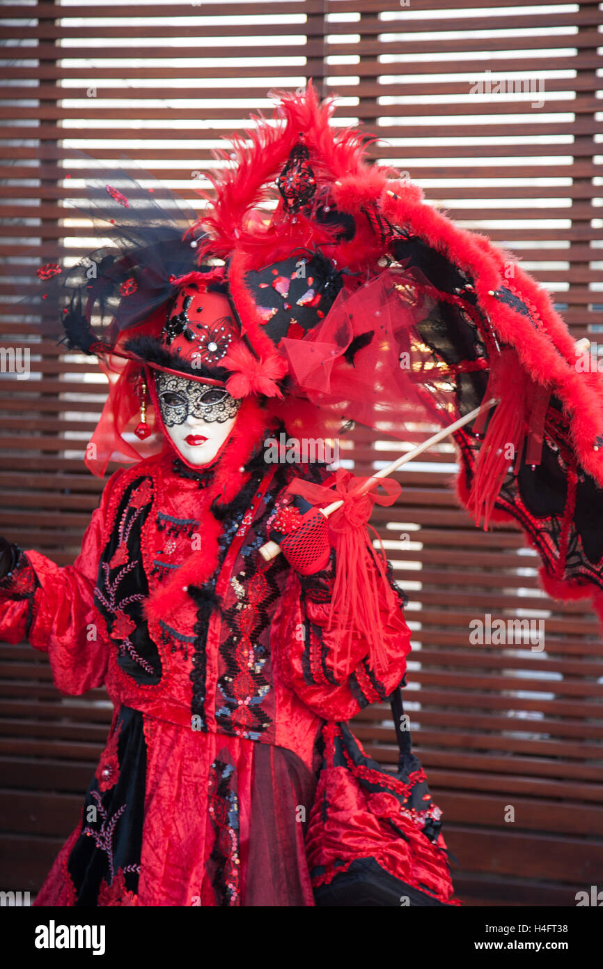 The red mask with umbrella, Venice, Italy Stock Photo - Alamy