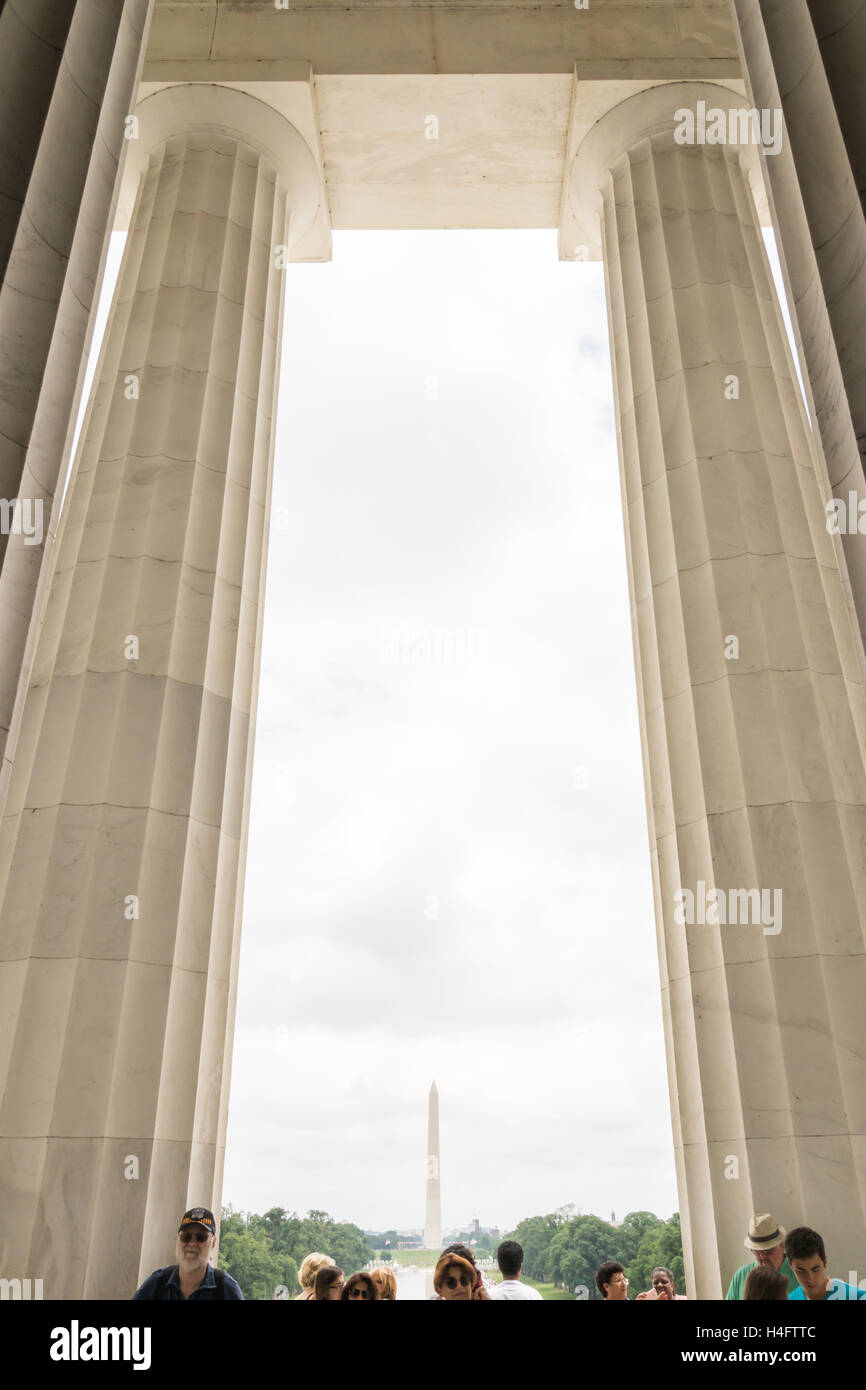 Upward view of the columns in the Lincoln Memorial with tourists and ...