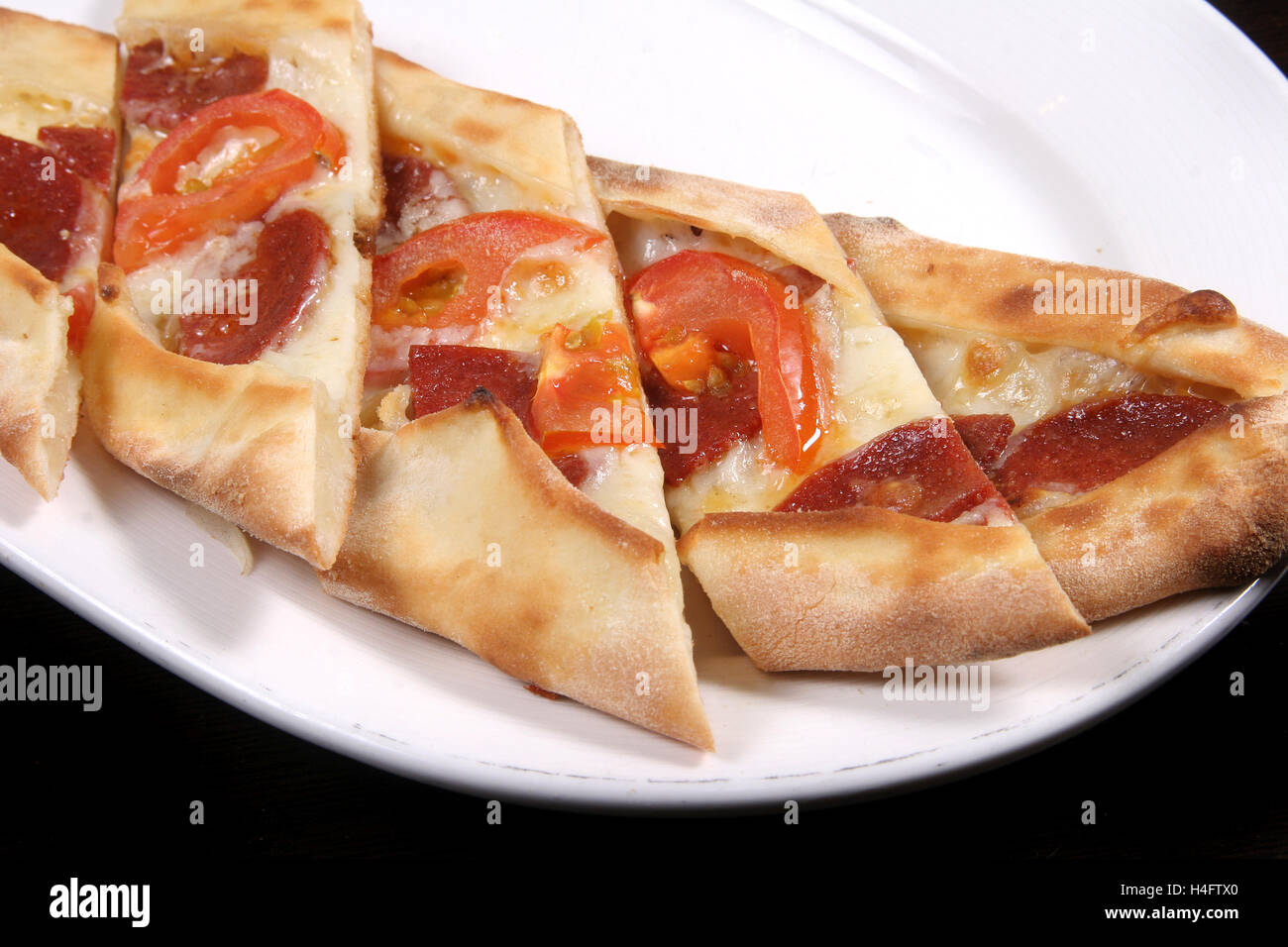 Turkish pizza (pide) Turkish sausage, tomatoes and cheddar cheese Stock ...