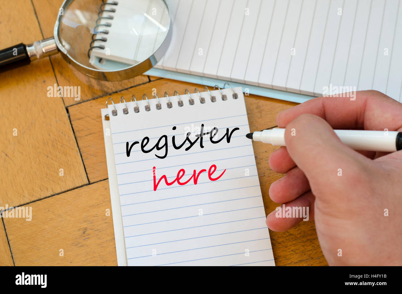 Register here text concept write on notebook Stock Photo - Alamy