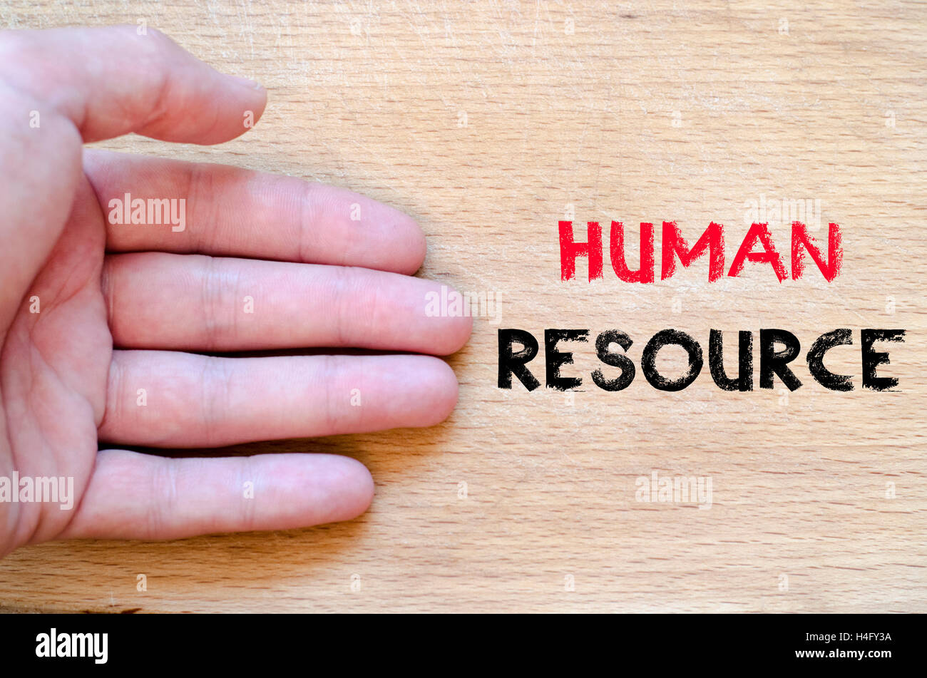 Human hand over wooden background and human resource text concept Stock ...