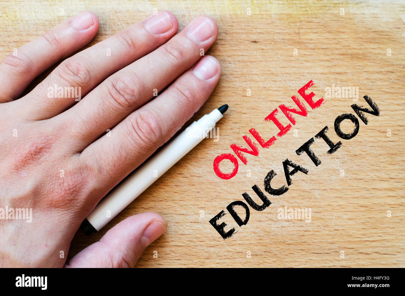 Human hand over wooden background and online education text concept ...