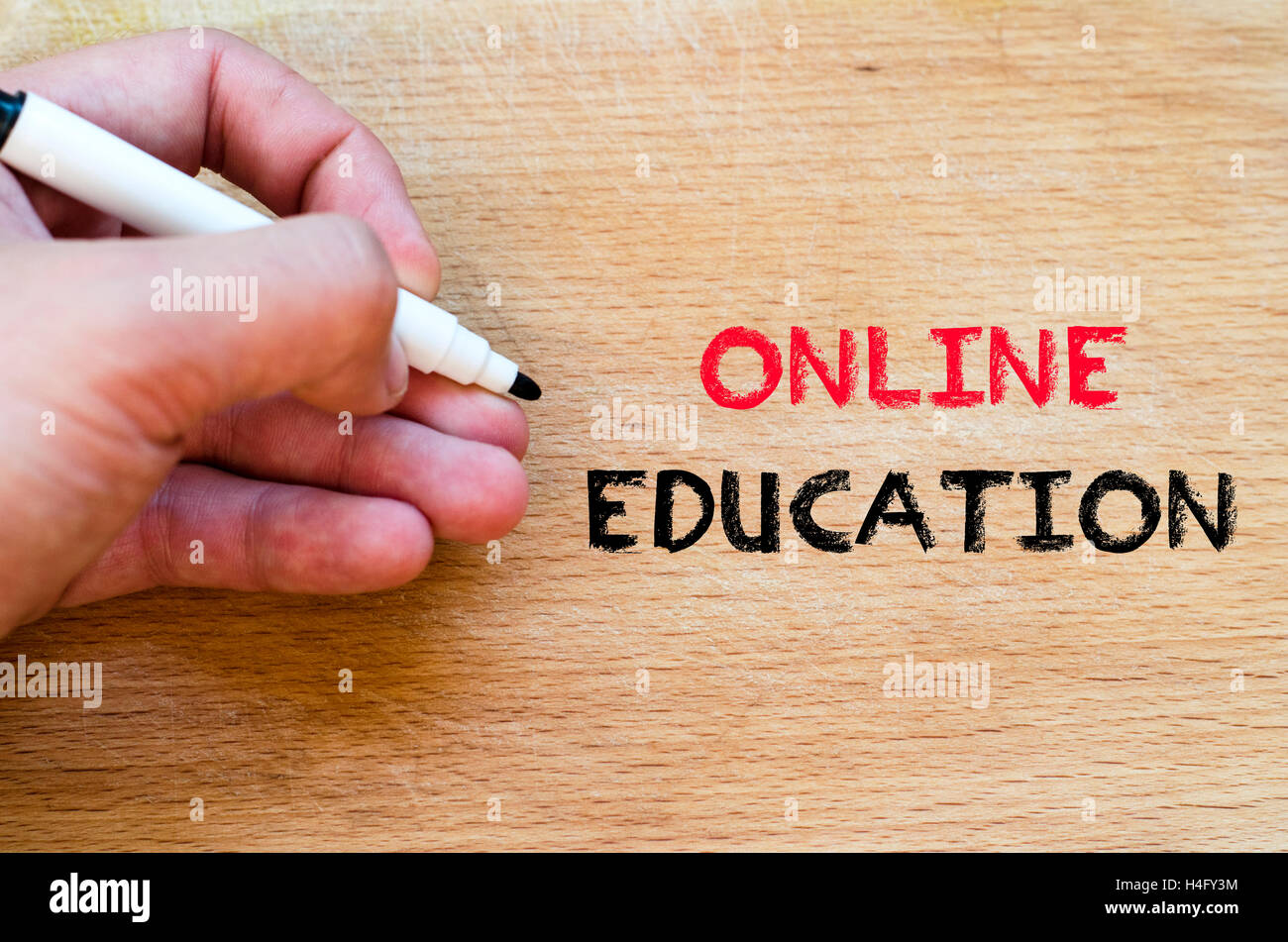 Human hand over wooden background and online education text concept ...