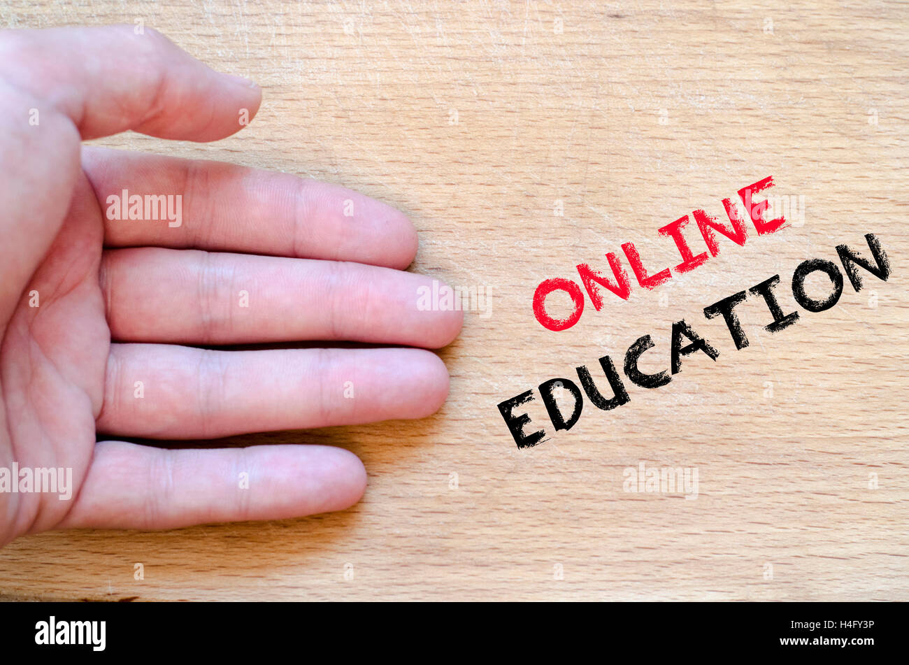 Human hand over wooden background and online education text concept ...