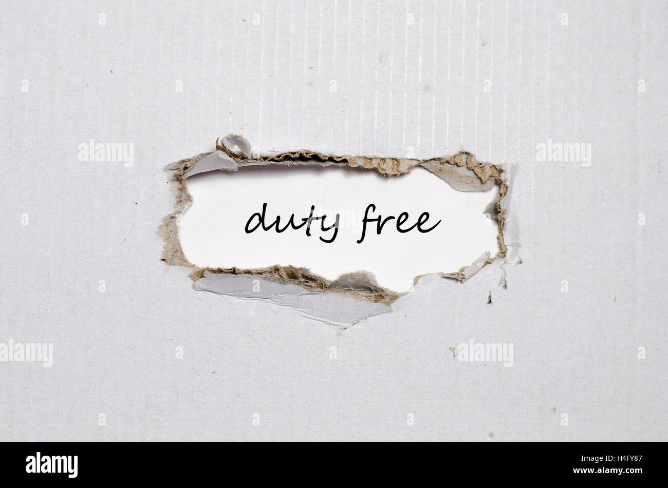 The word duty free appearing behind torn paper Stock Photo - Alamy