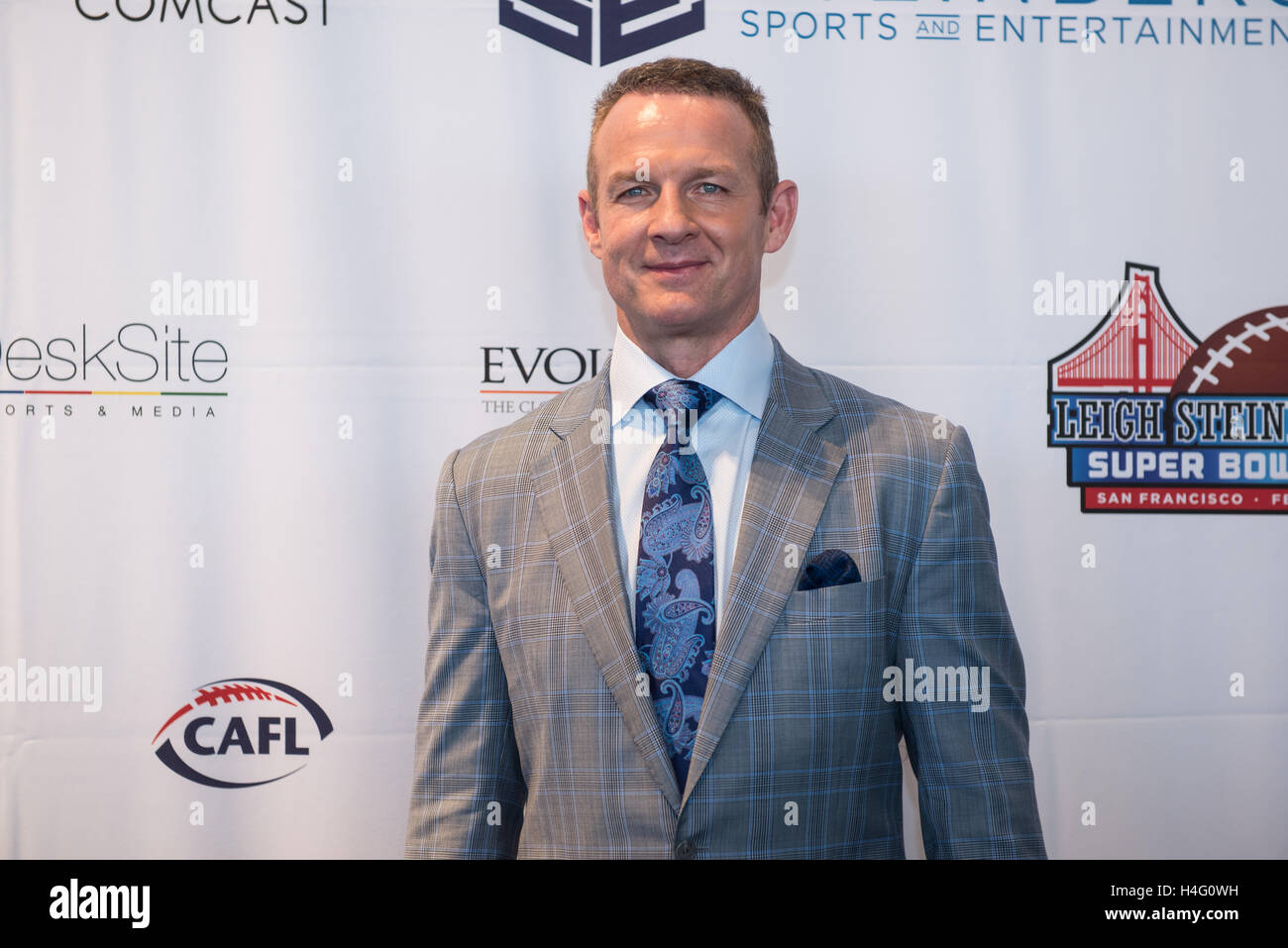 Merril Hoge poses on the red carpet at the Leigh Steinberg Super Bowl ...