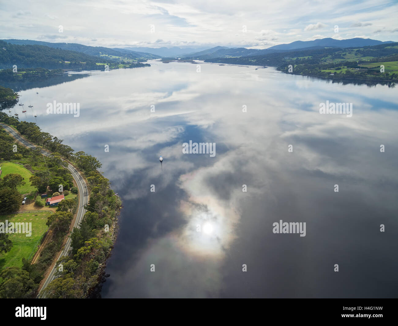 Aerial panorama of Huon River with clouds reflecting in the water. Huon ...