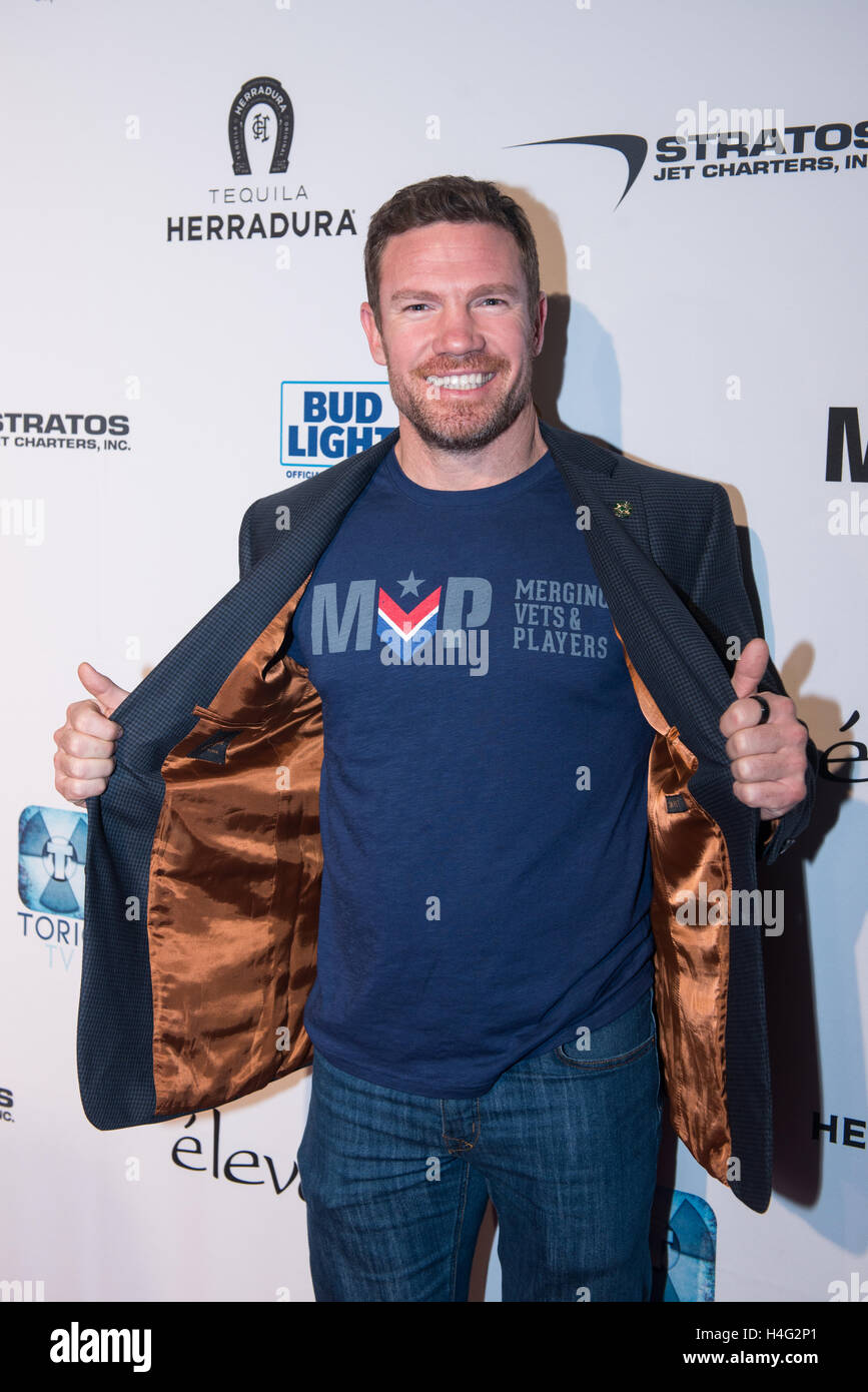 Nate Boyer poses for a photo with his Merging Vets + Players shirt at ...