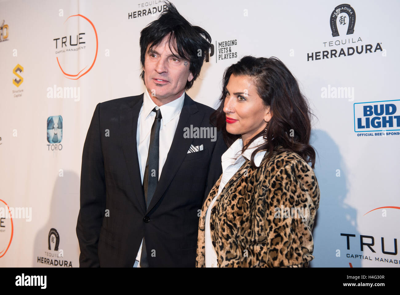 Tommy Lee poses with his fiance Sofia Toufa for a photo at the Glazer ...