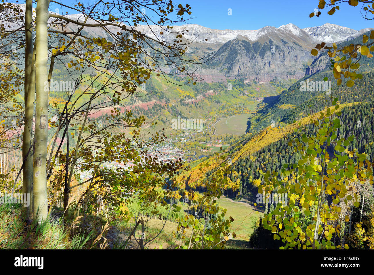 view of Telluride in the fall with yellow aspen and snow covered ...