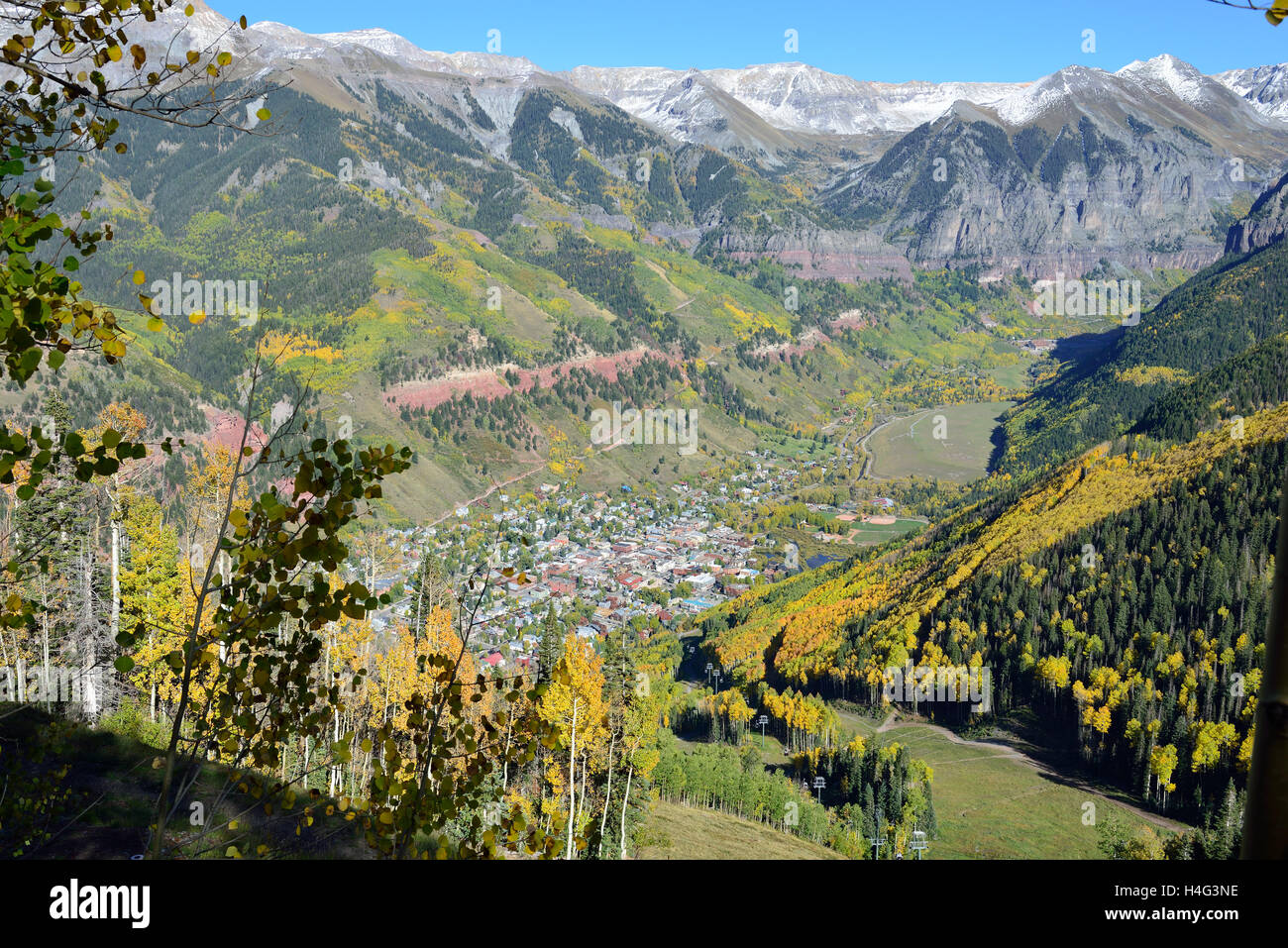 view of Telluride in the fall with yellow aspen and snow covered ...