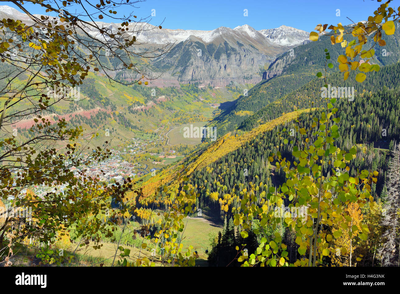 view of Telluride in the fall with yellow aspen and snow covered ...
