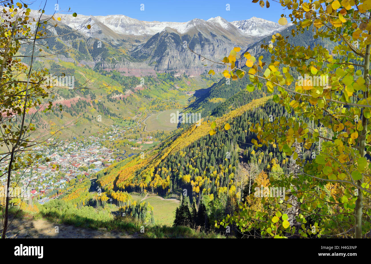 view of Telluride in the fall with yellow aspen and snow covered ...