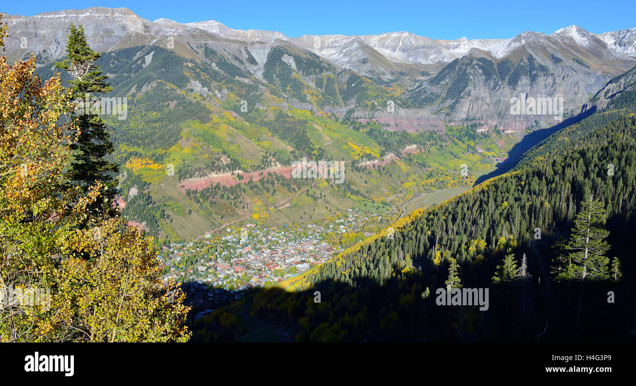 view of Telluride in the fall with yellow aspen and snow covered ...