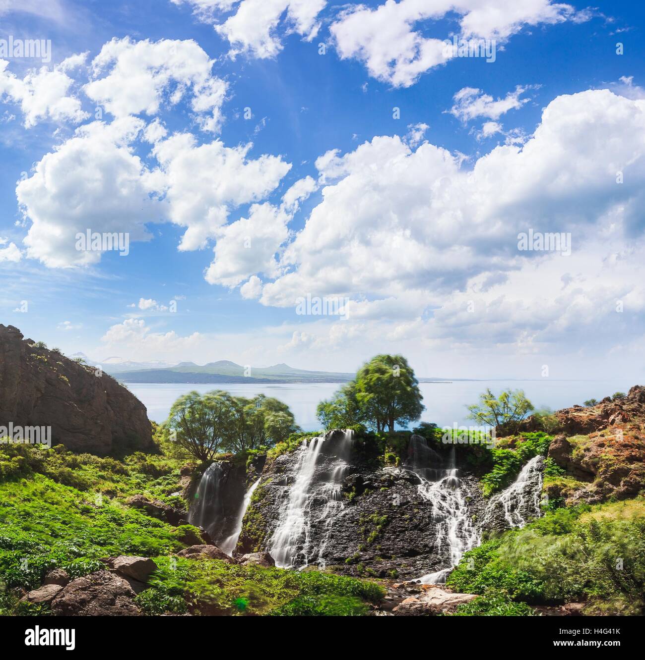 mountain waterfall with blue cloudy sky Stock Photo - Alamy