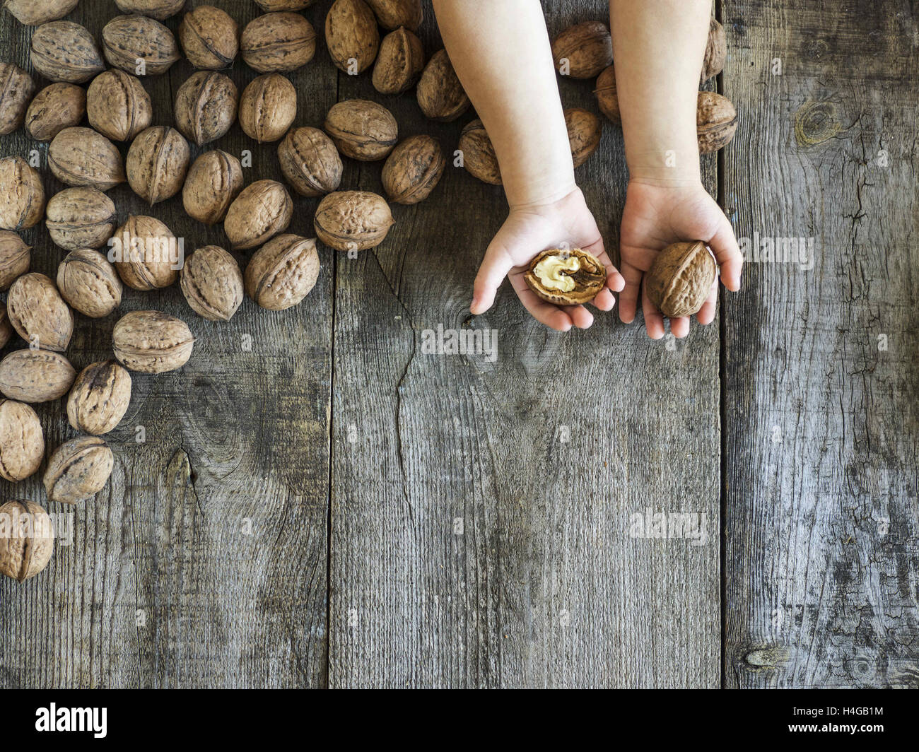 Child Hands Gets Organic Walnuts On Vintage Wooden Background. 16th Oct ...