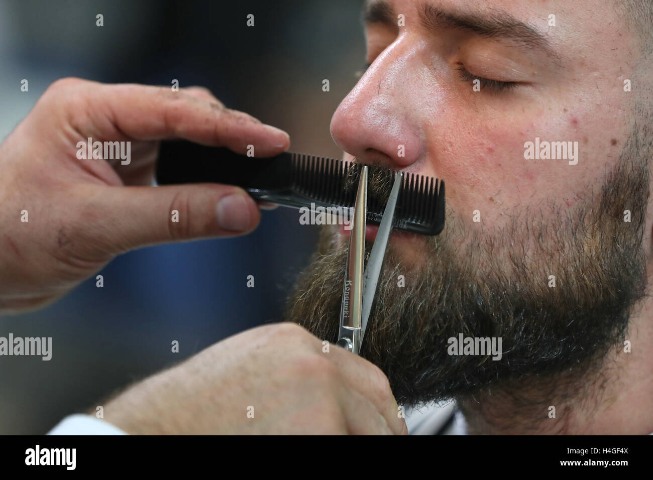 Sezer Soylu, winner of the German barber Awards 2016, works on a model ...