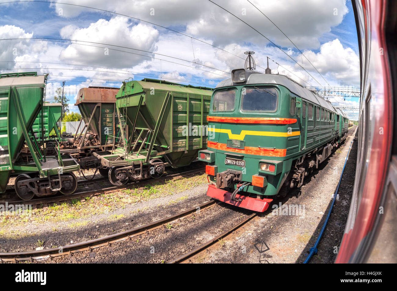 Freight train standing at a railway station in summer day. Cargo train ...