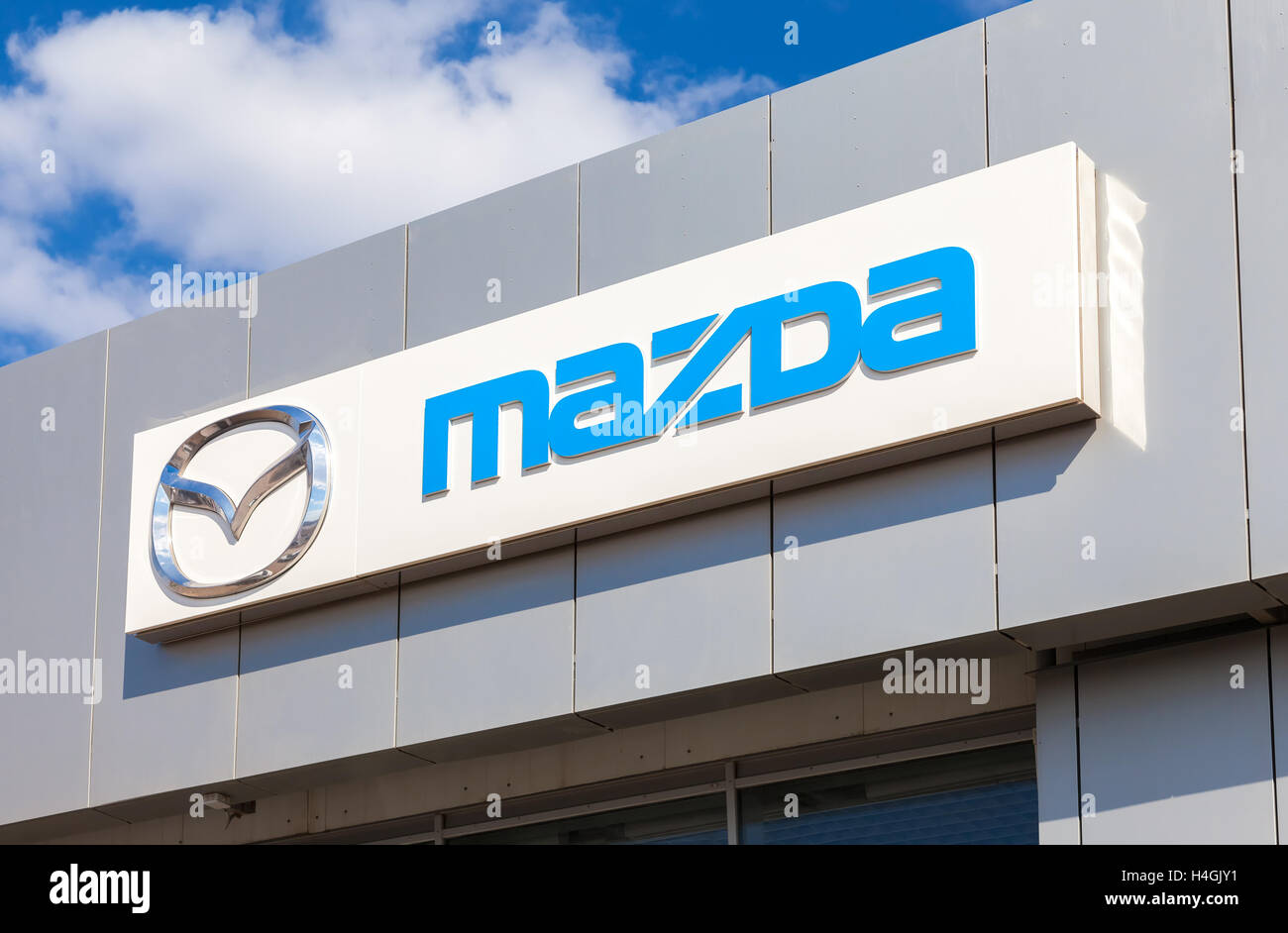 Mazda logo on the facade of official dealer office Stock Photo - Alamy