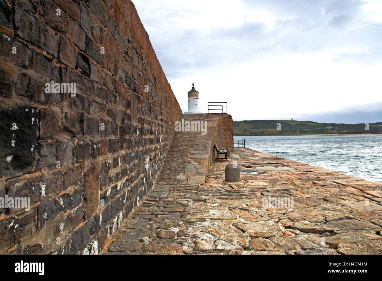 A view of the harbour breakwater wall and light at Banff, Aberdeenshire ...