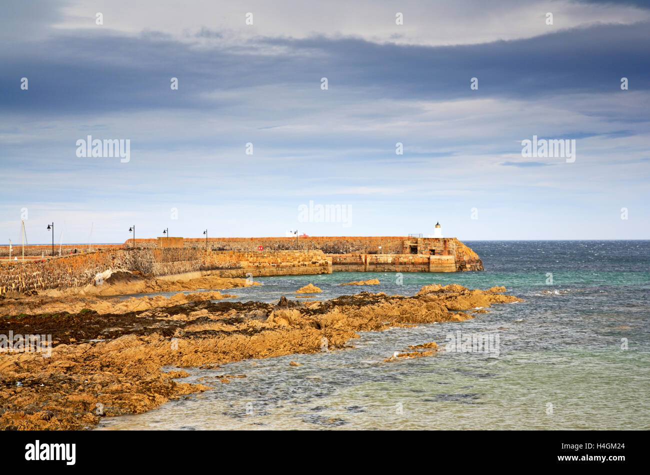 A view of the rocky shoreline and entrance to the harbour at Banff ...