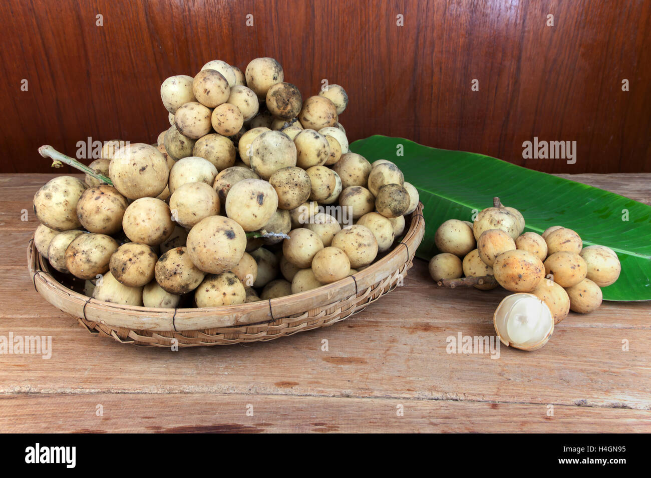 Longkong,Langsat or Lanzones fruit piled in a basket on wood table ...