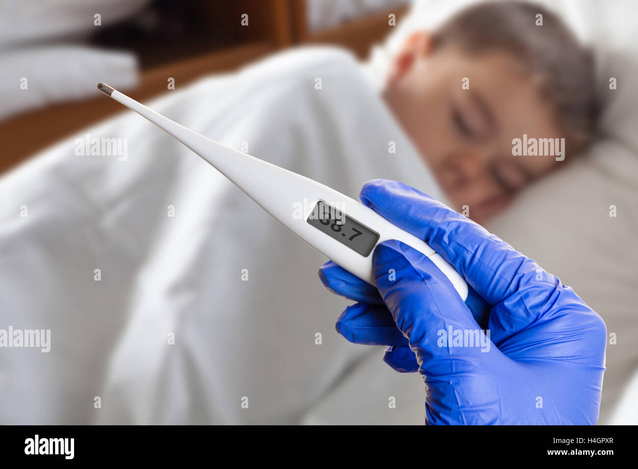 thermometer in hand on a background sick child Stock Photo - Alamy