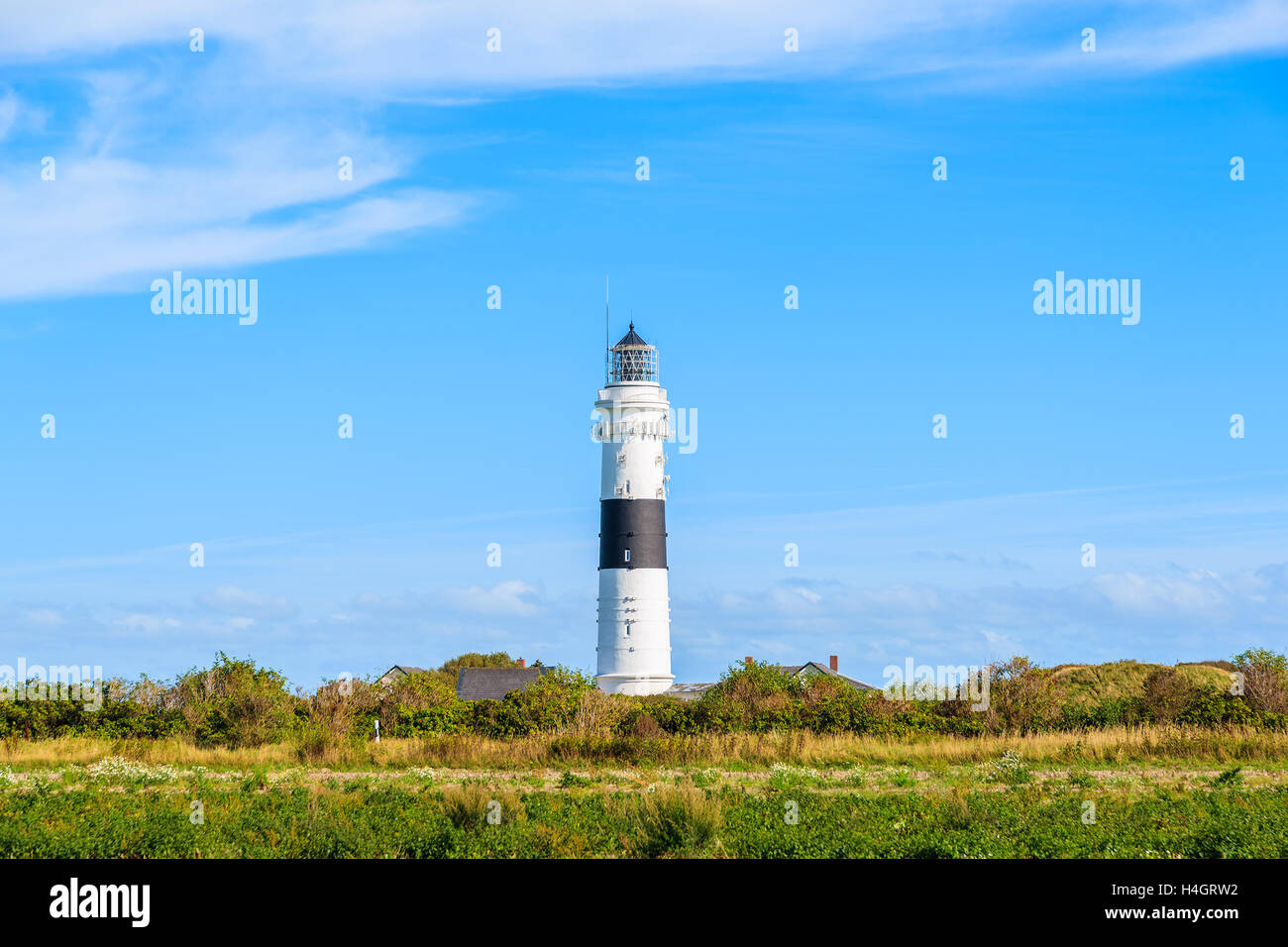 Lighthouse on green meadow in countryside landscape of Sylt island ...