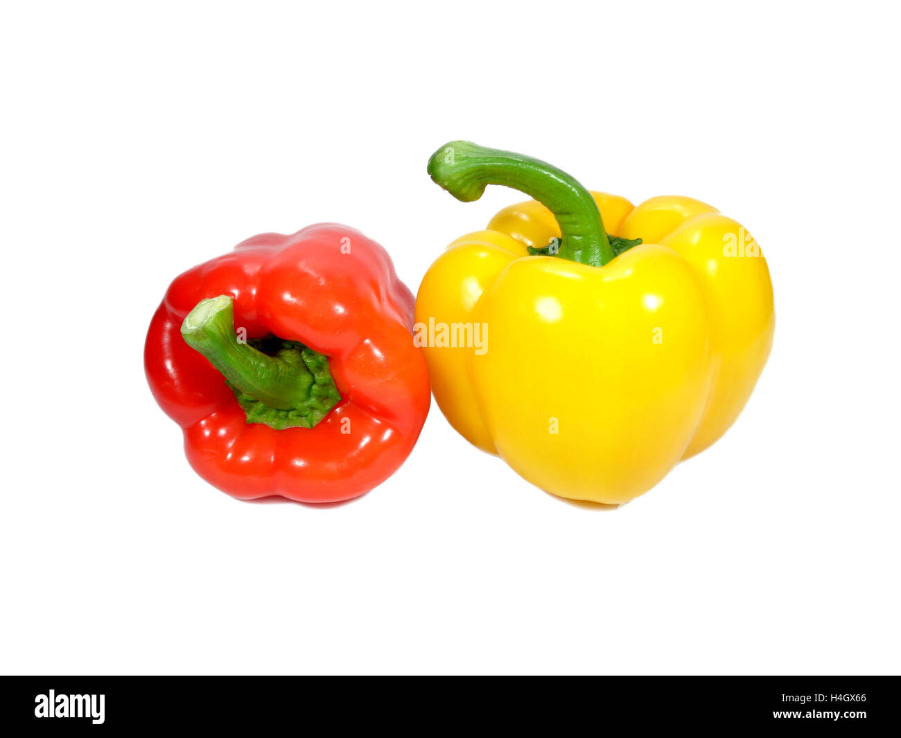 Two ripe bell peppers, one red and one yellow with green stem isolated ...