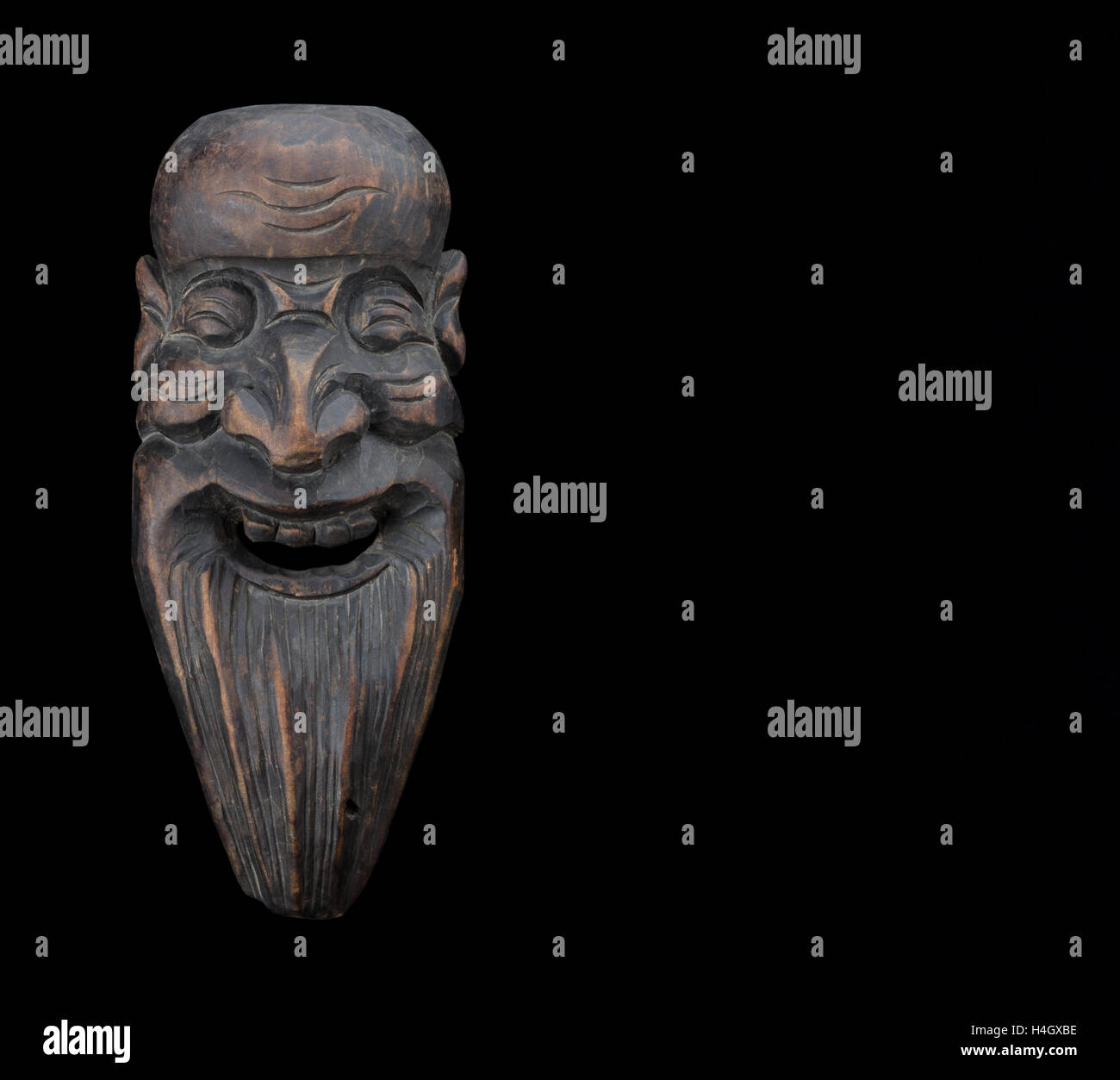 bearded man mask made of wood, color dark brown, free space for text ...