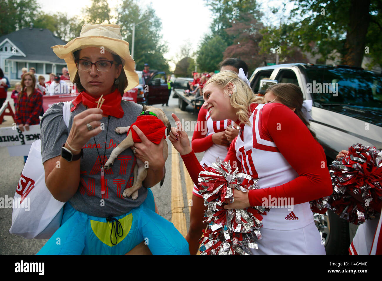 Cheerleader petting puppy. IU homecoming parade. (Photo by Jeremy Hogan ...