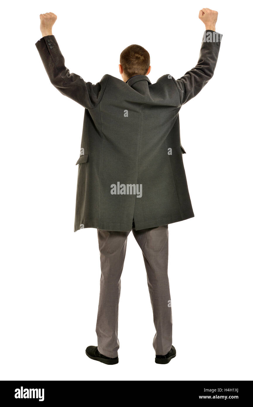 Man in coat with hands up Stock Photo - Alamy